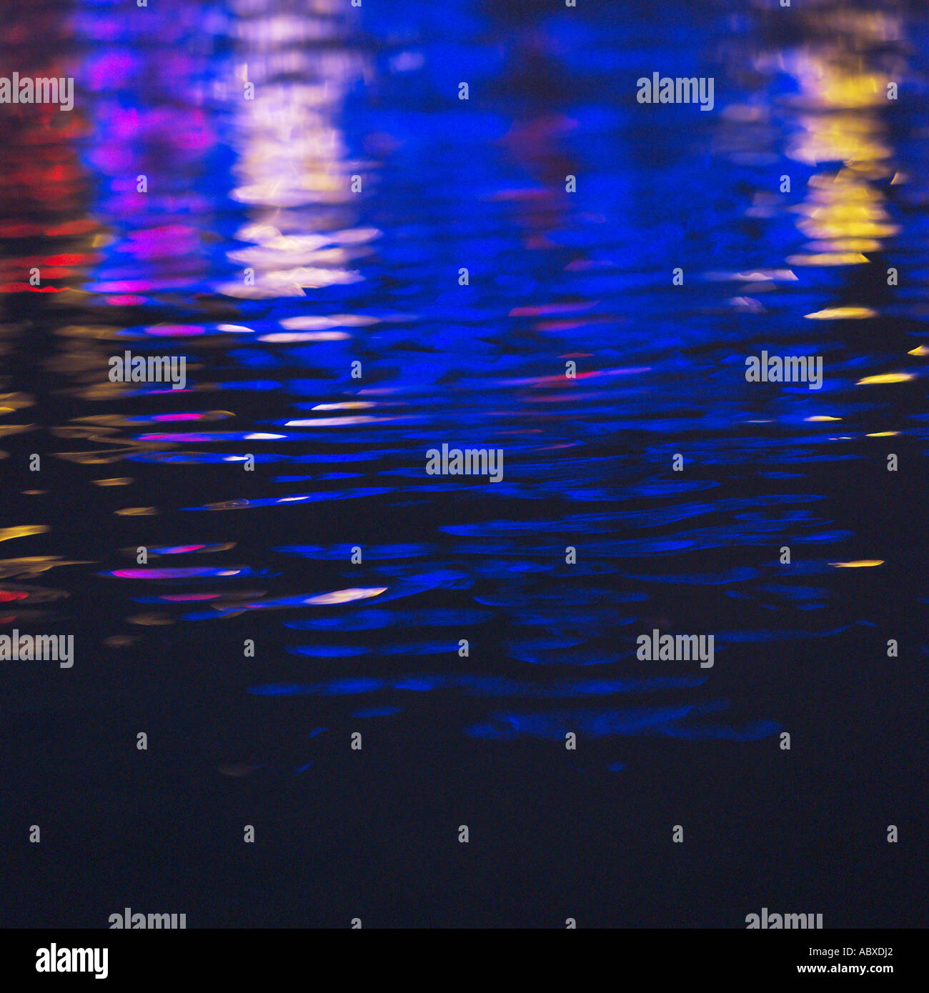 Colorful lights reflected on water surface Stock Photo - Alamy