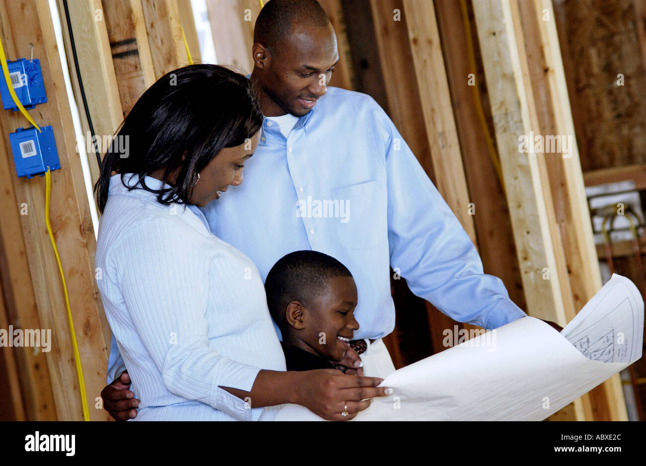 Family looking at their new home plans Stock Photo - Alamy