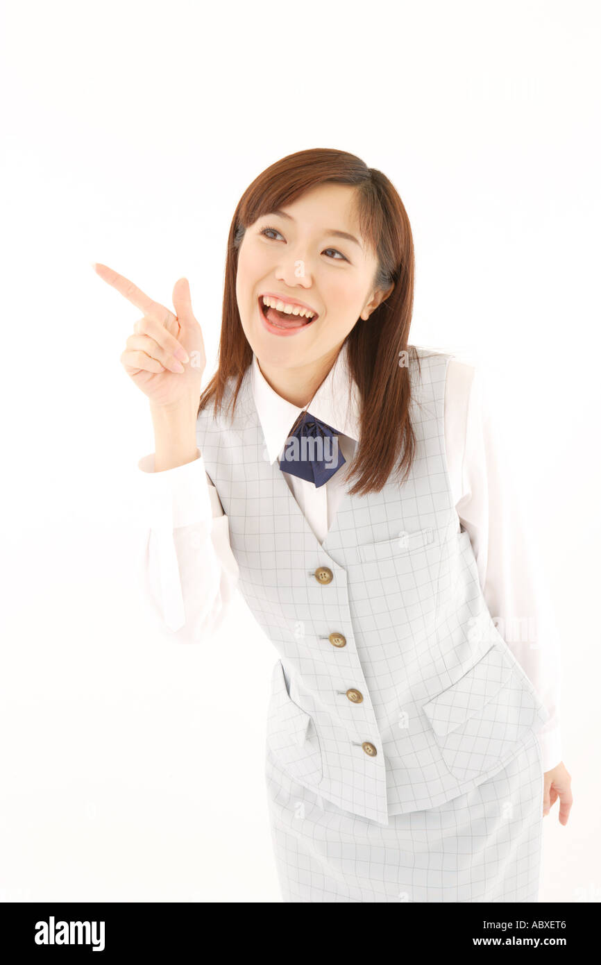 A woman in formal attire pointing a direction Stock Photo - Alamy