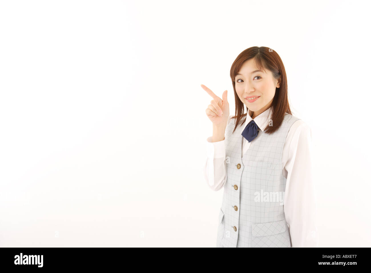 A woman in formal attire pointing a direction Stock Photo - Alamy