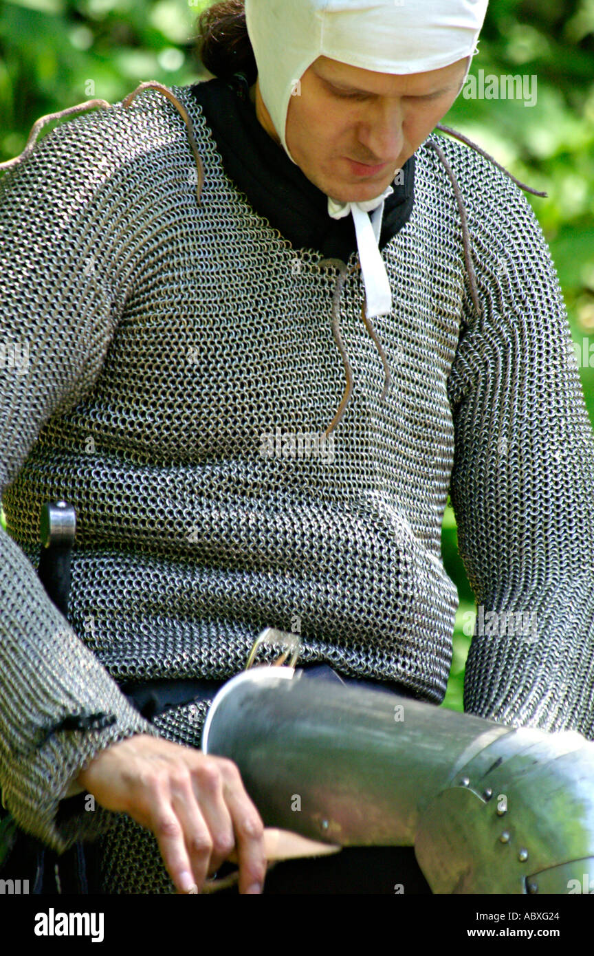 Medieval Knight Dressing himself into plate armour, detail Stock Photo ...