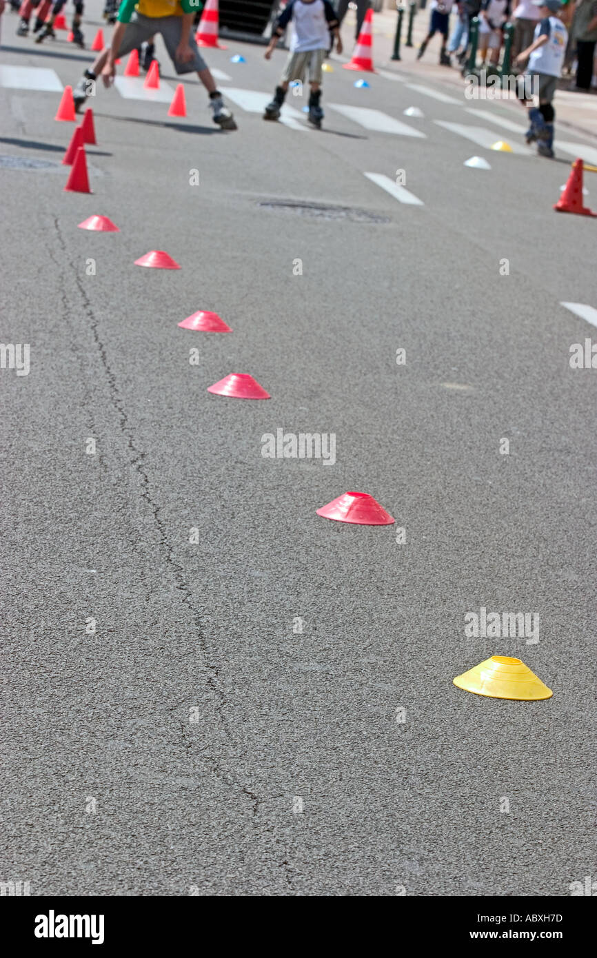 kids children roller blading through slalom cones Stock Photo - Alamy
