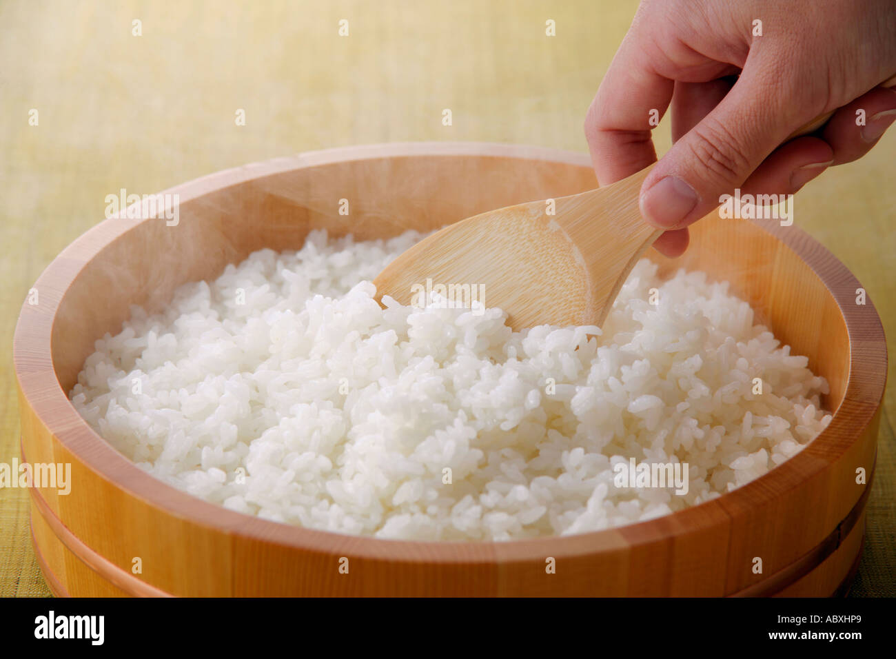 A woman scooping steamed rice Stock Photo - Alamy