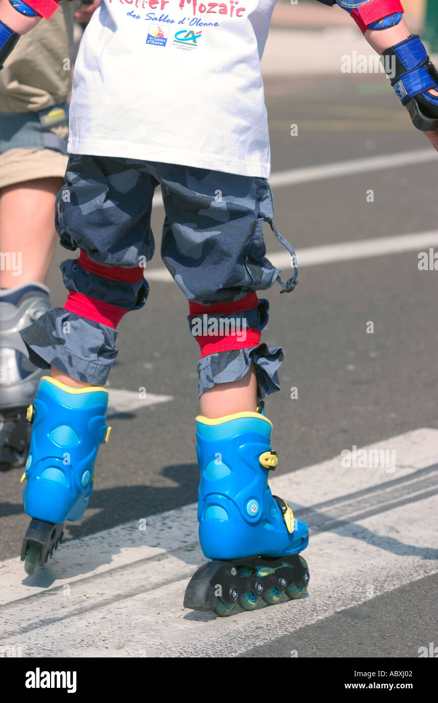kids children roller blading on the street with protection of body ...