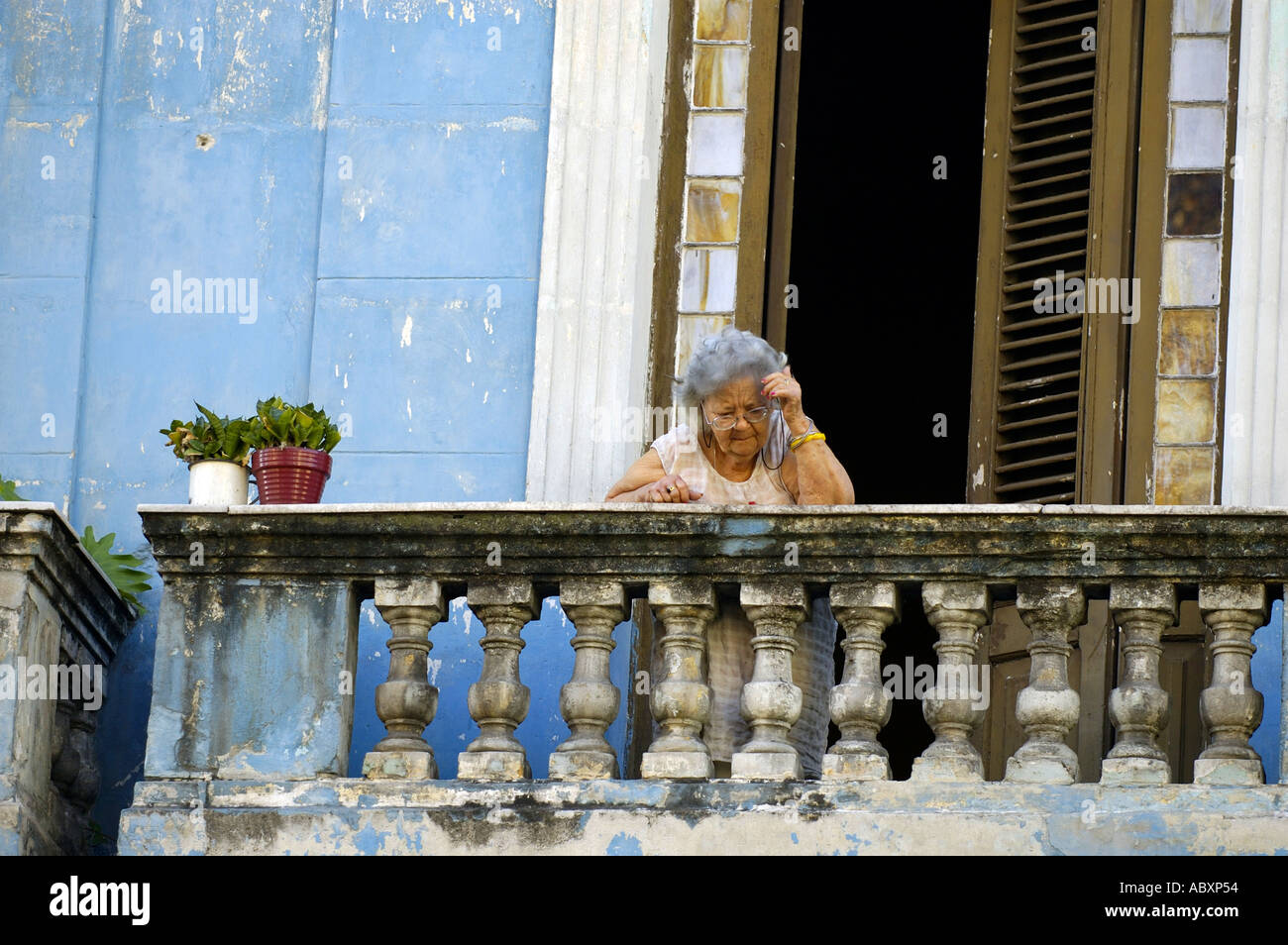 woman looking over balcony of building Havana Cuba Stock Photo - Alamy