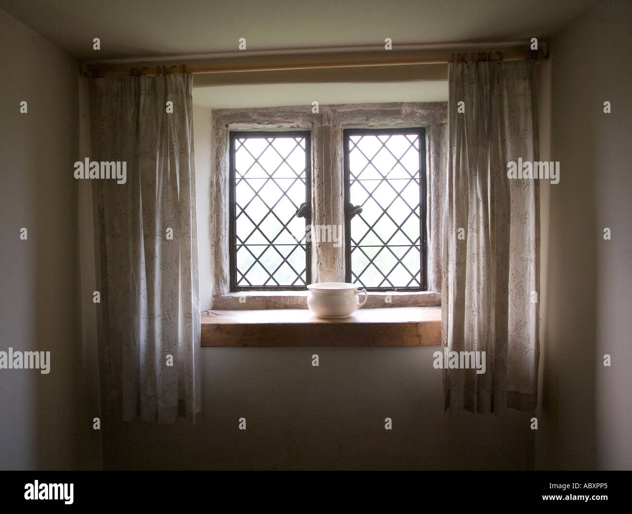Window with leaded lights in bedroom in Treowen manor house ...