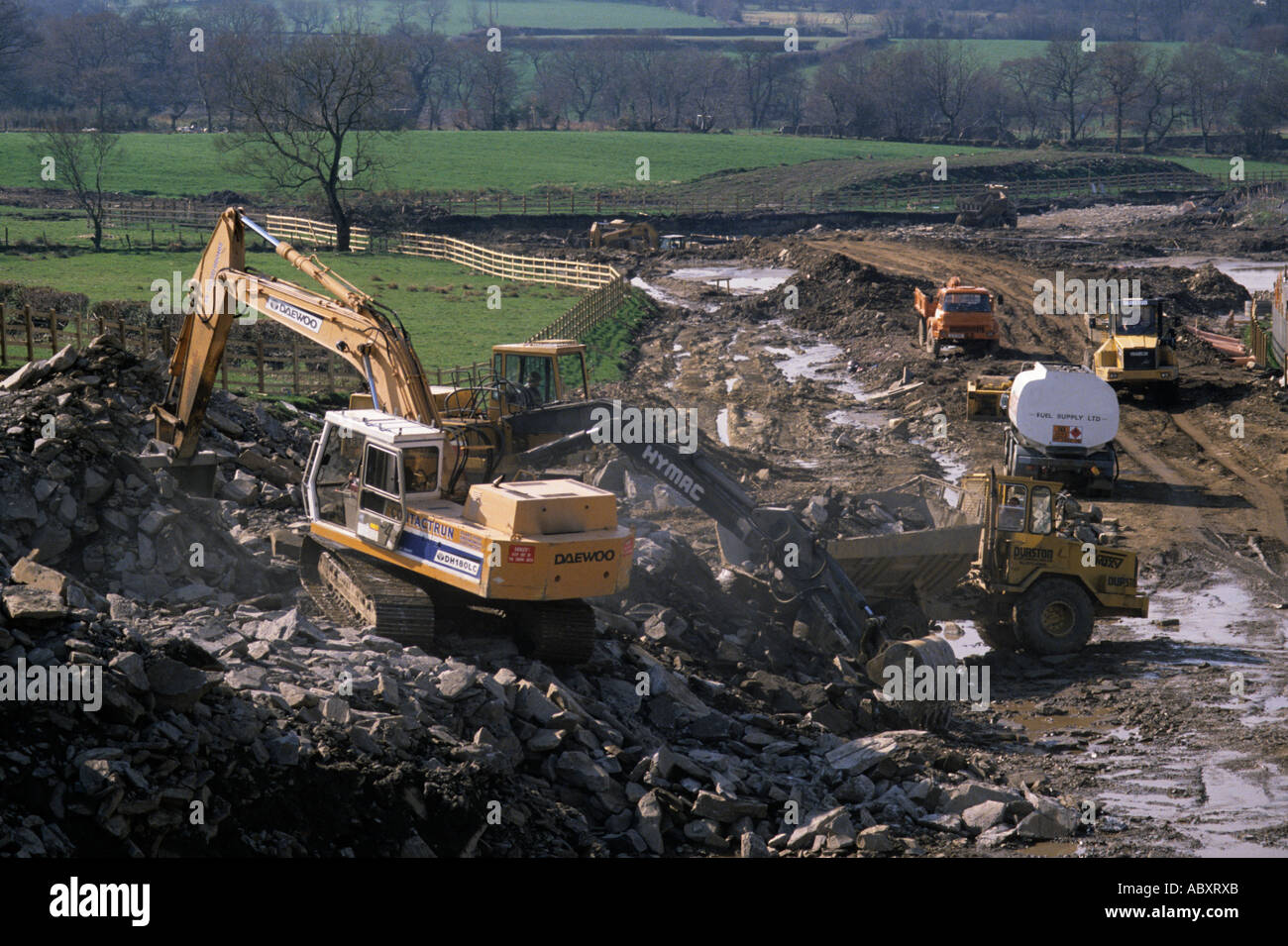 Excavator loading lorry during road construction Caerphilly Wales UK ...