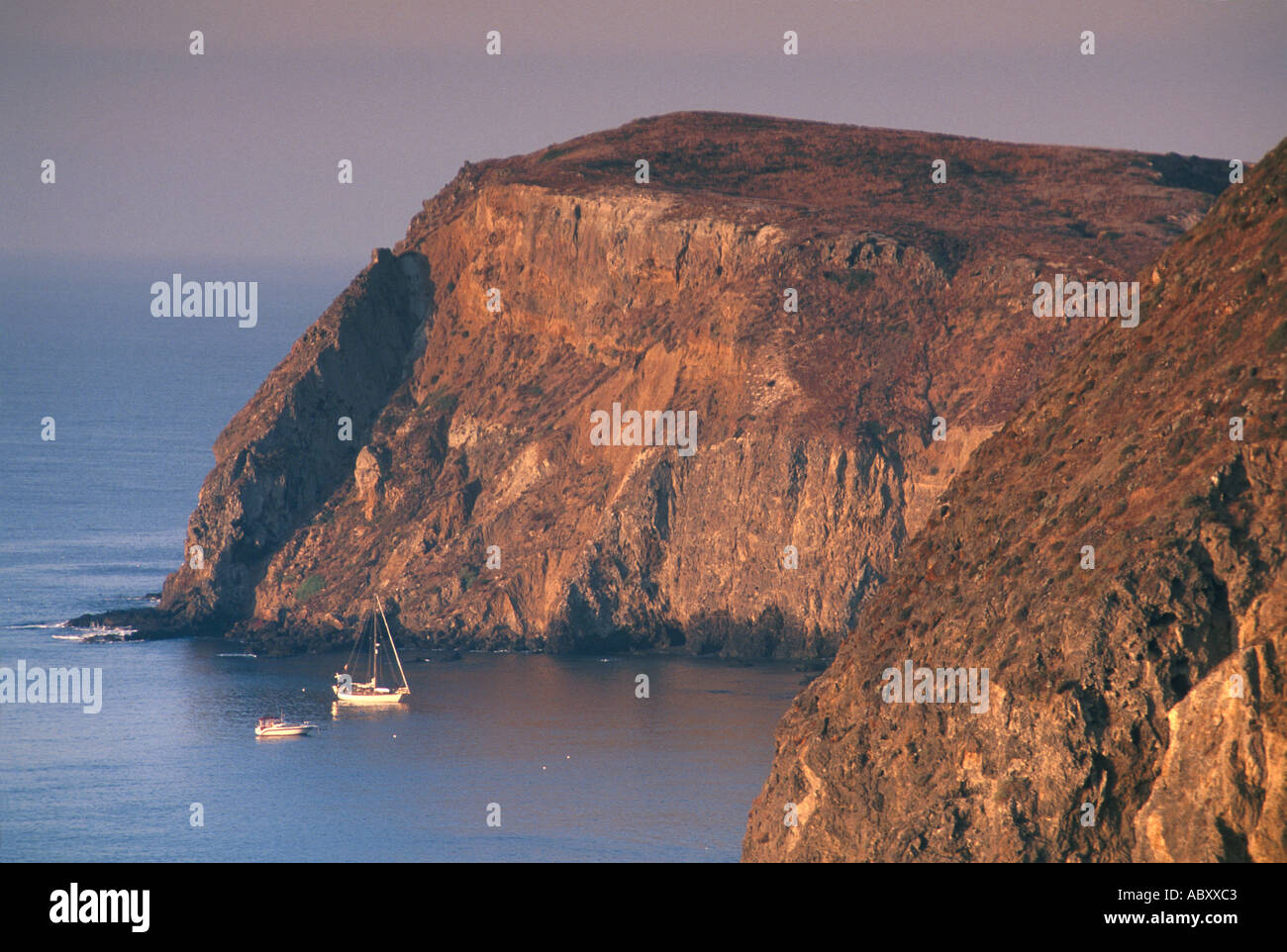 Sailboat anchored below steep coastal cliffs Anacapa Island Channel ...