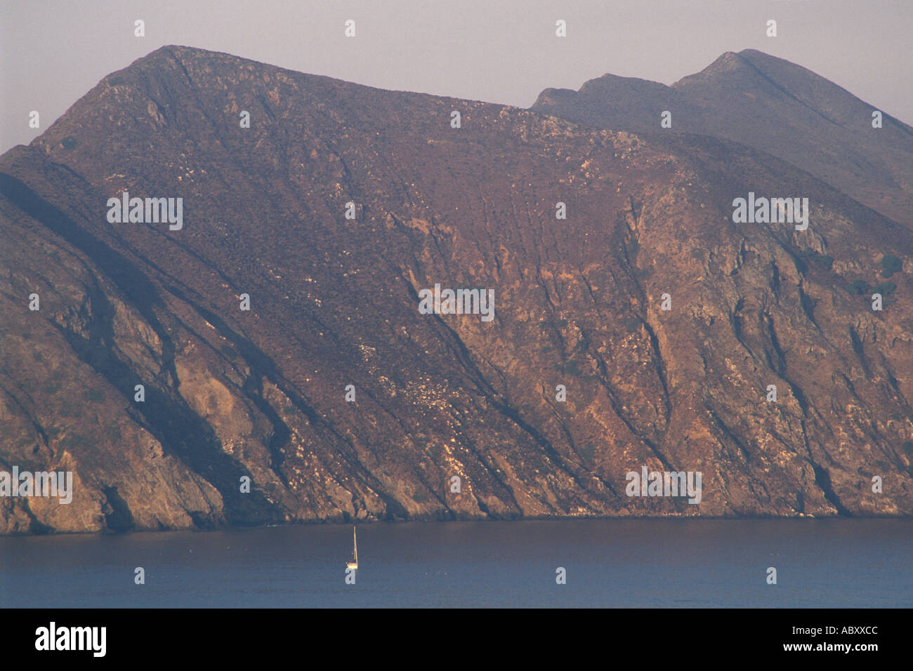 Sailboat anchored below steep coastal cliffs Anacapa Island Channel ...
