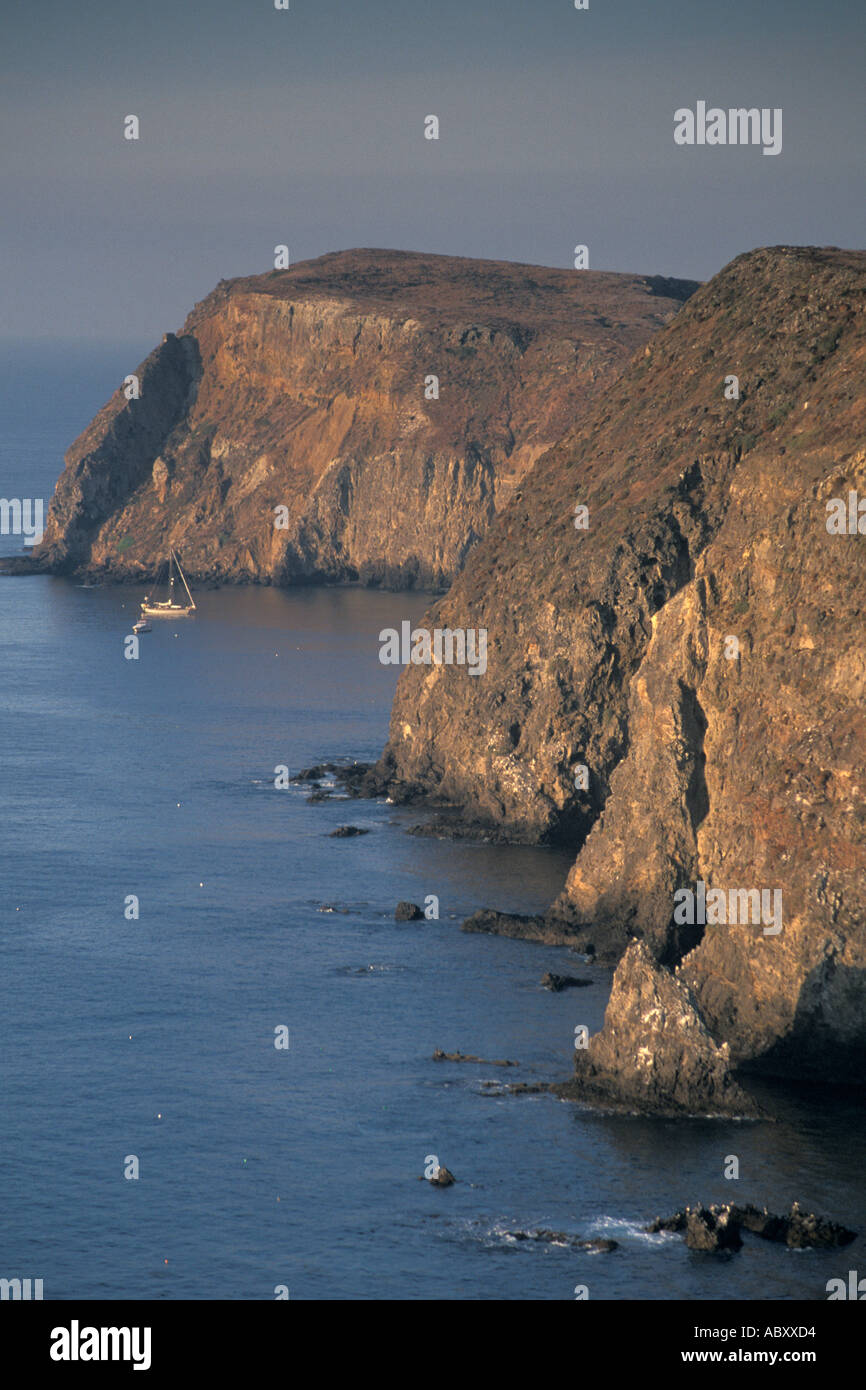 Sailboat anchored below steep coastal cliffs Anacapa Island Channel ...