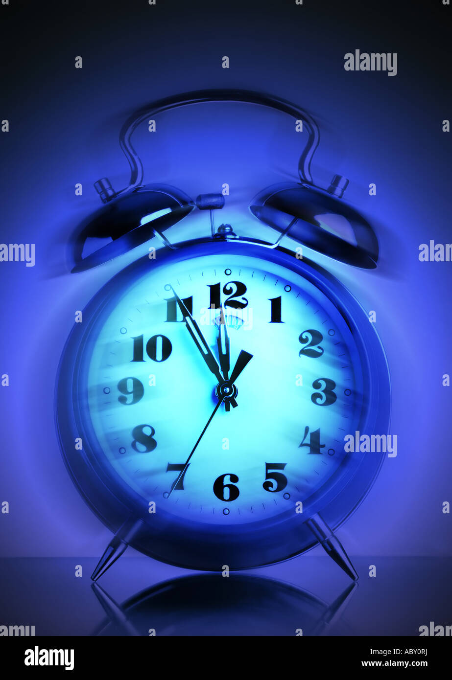 Ringing old style alarm clock movement blur Stock Photo - Alamy