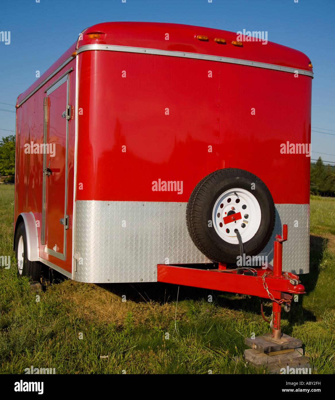 Red trailer in a field Stock Photo - Alamy