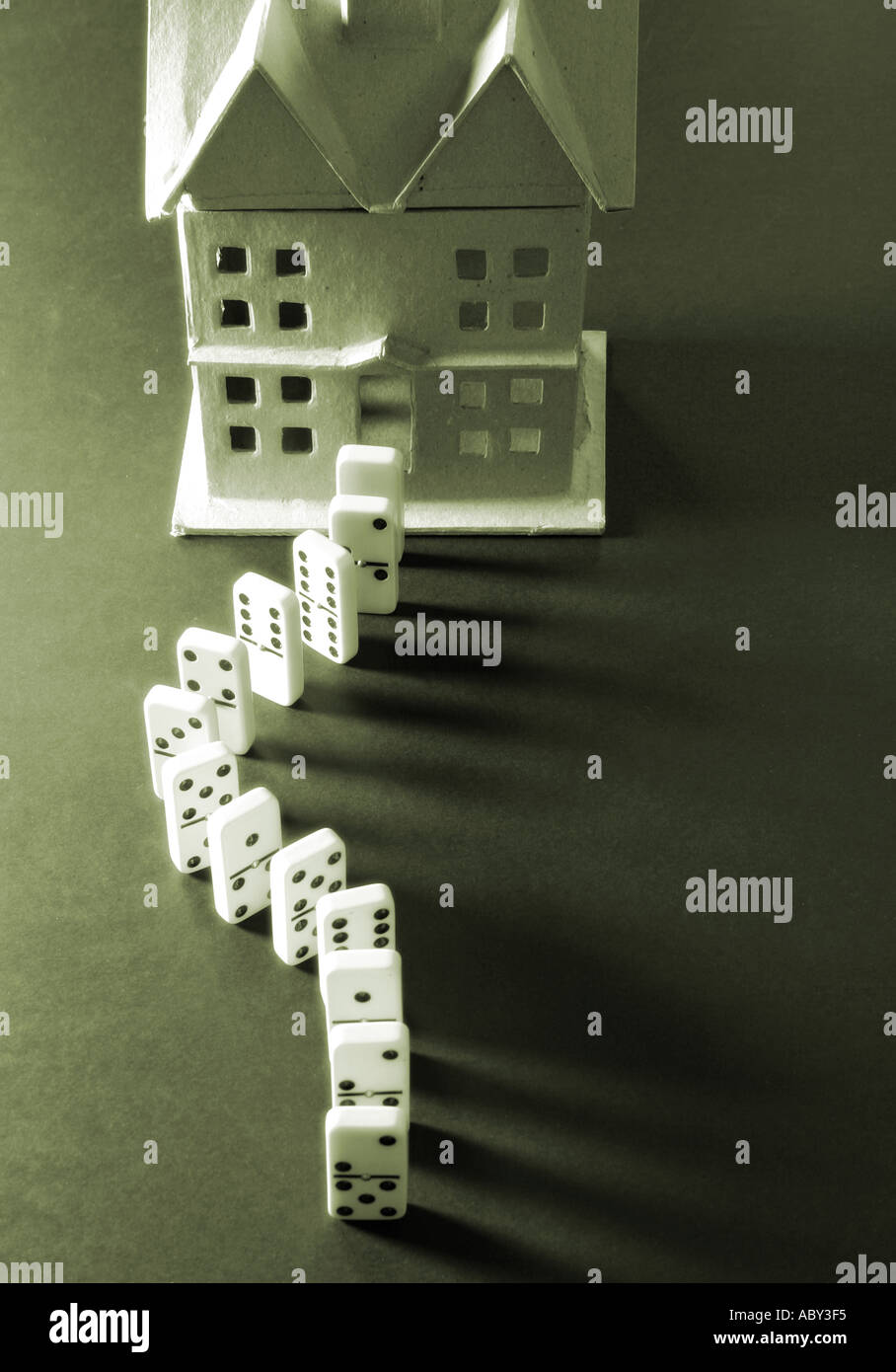 Conceptual image showing a house at the end of a line of dominoes Stock ...