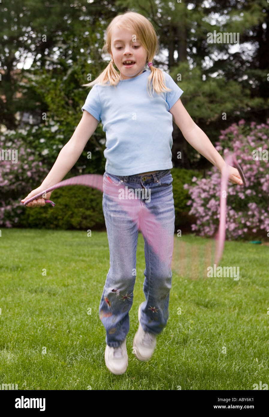Young child jumping rope Stock Photo - Alamy