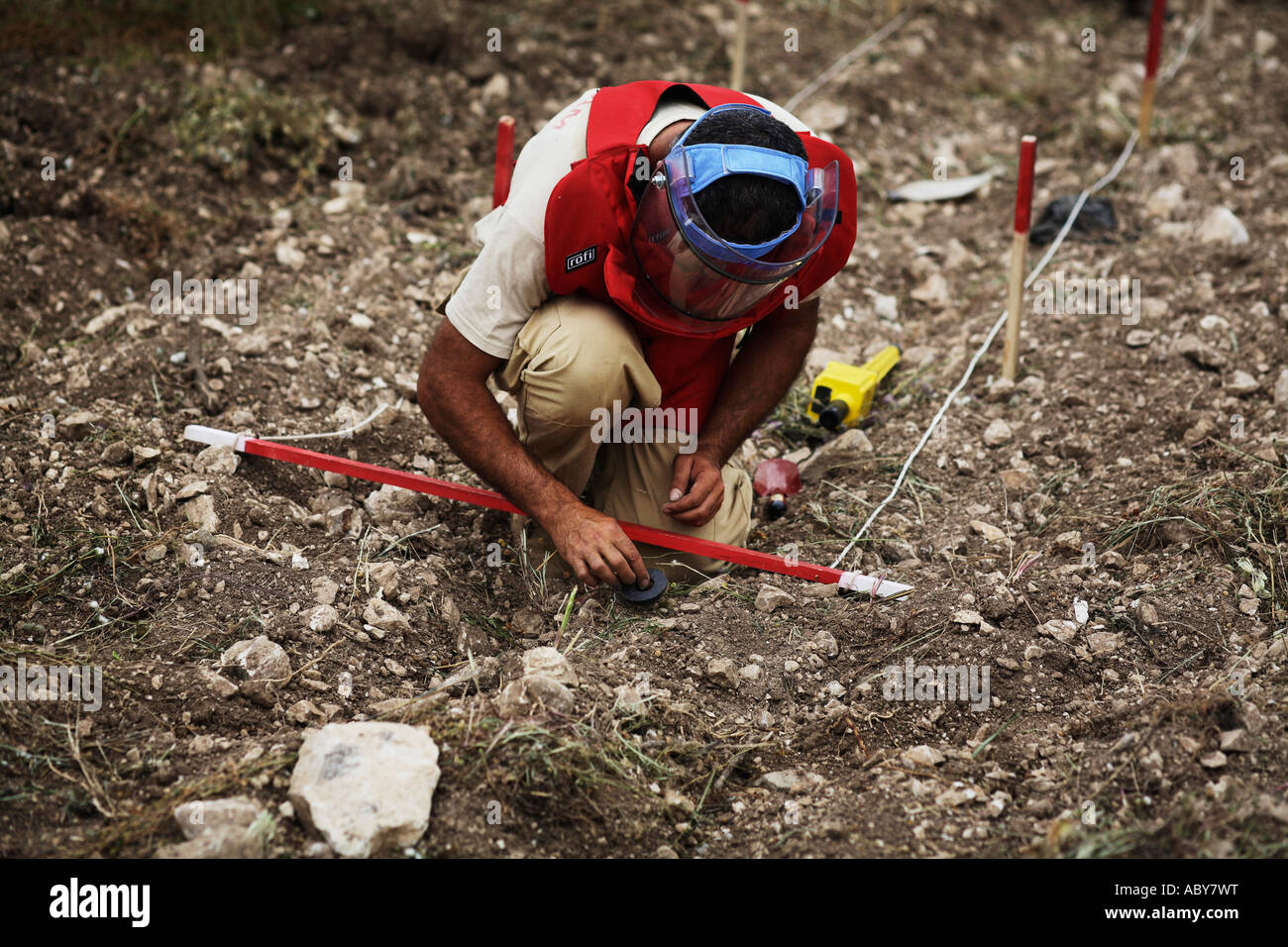 Searching for cluster bombs using metal detector and magnetic sweeper ...