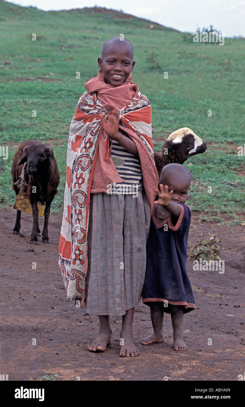 KENYA Masai Mara National Reserve Young Masai girl in traditional kanga ...