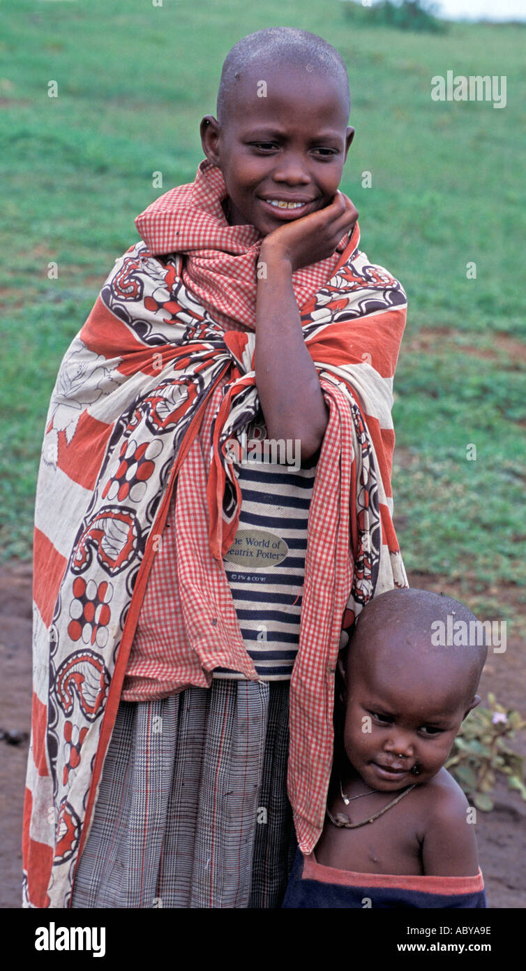 KENYA Masai Mara National Reserve Young Masai girl in traditional kanga ...