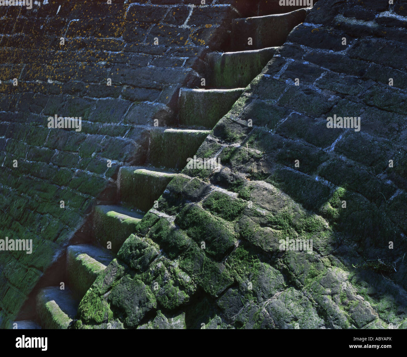 Horizontal colour picture of stone steps built into a harbour wall ...