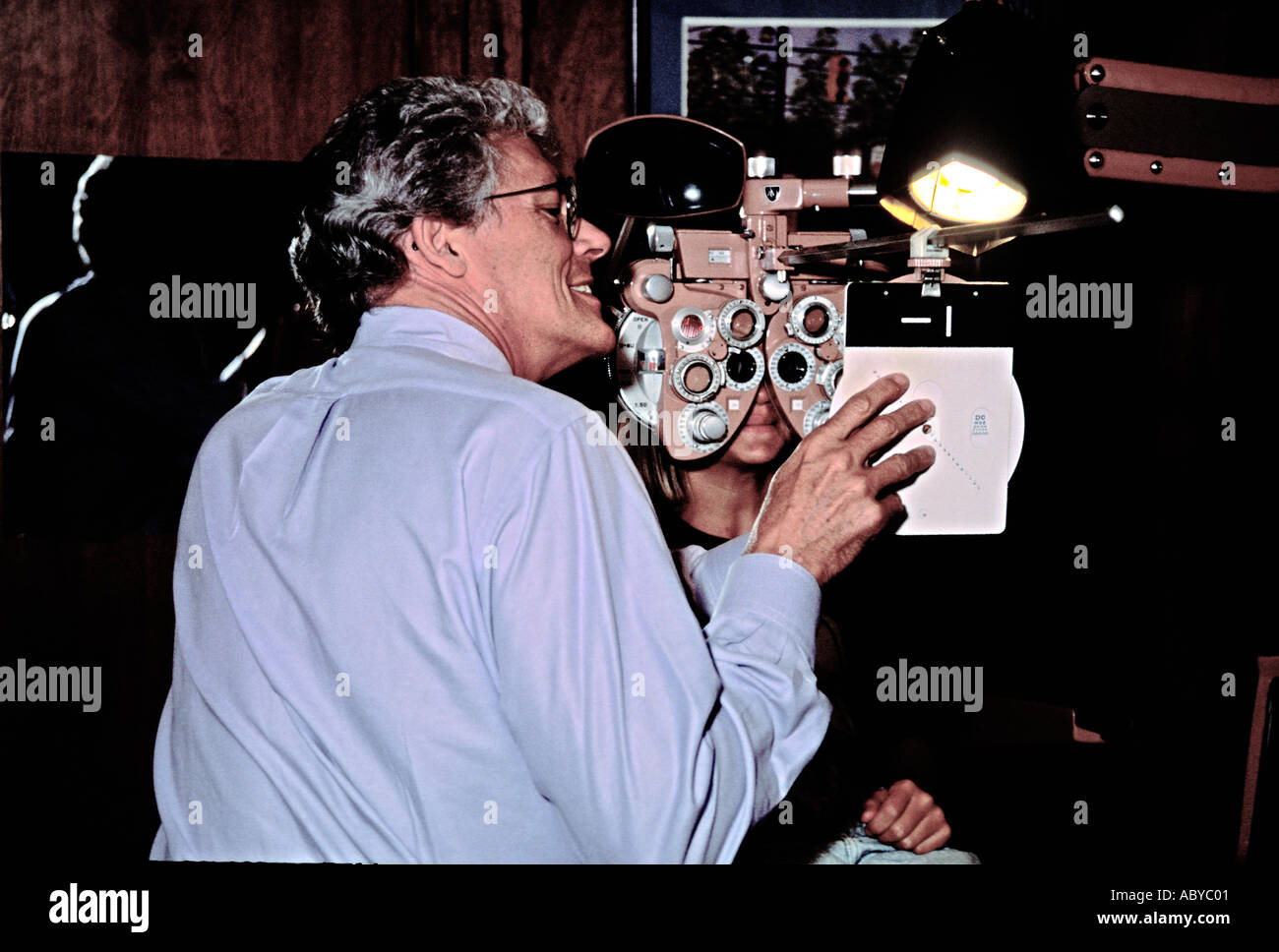 Optometrist Examines Child S Close Vision Using Phoropter With optometrist-examines-child-s-close-vision-using-phoropter-with