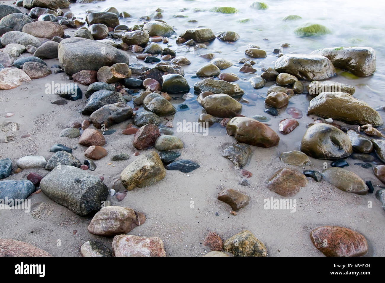 Stones in the surf, Close-up of stones on beach Stock Photo - Alamy