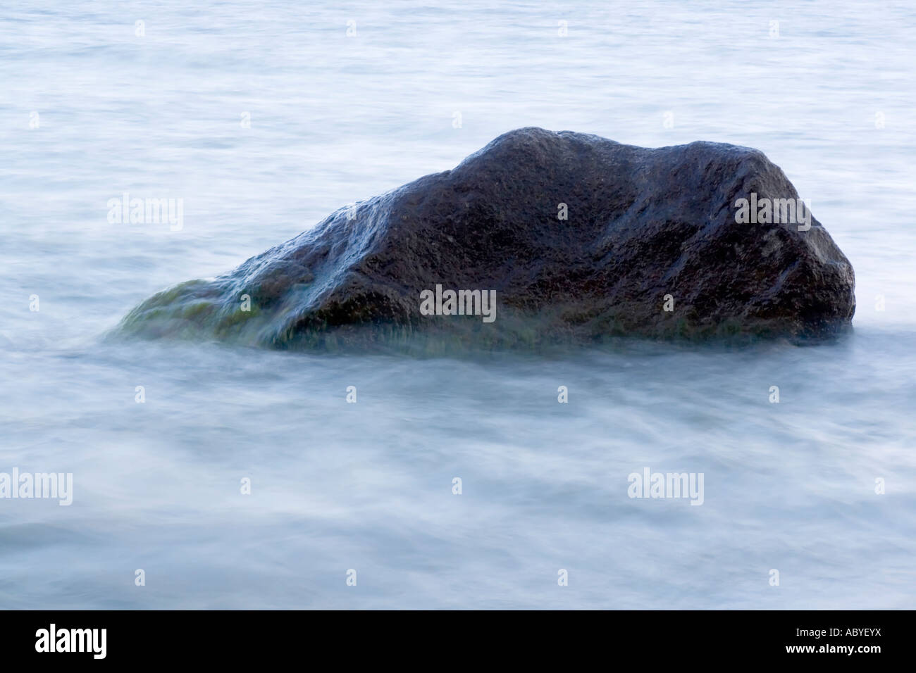 Stones in the surf Stock Photo - Alamy