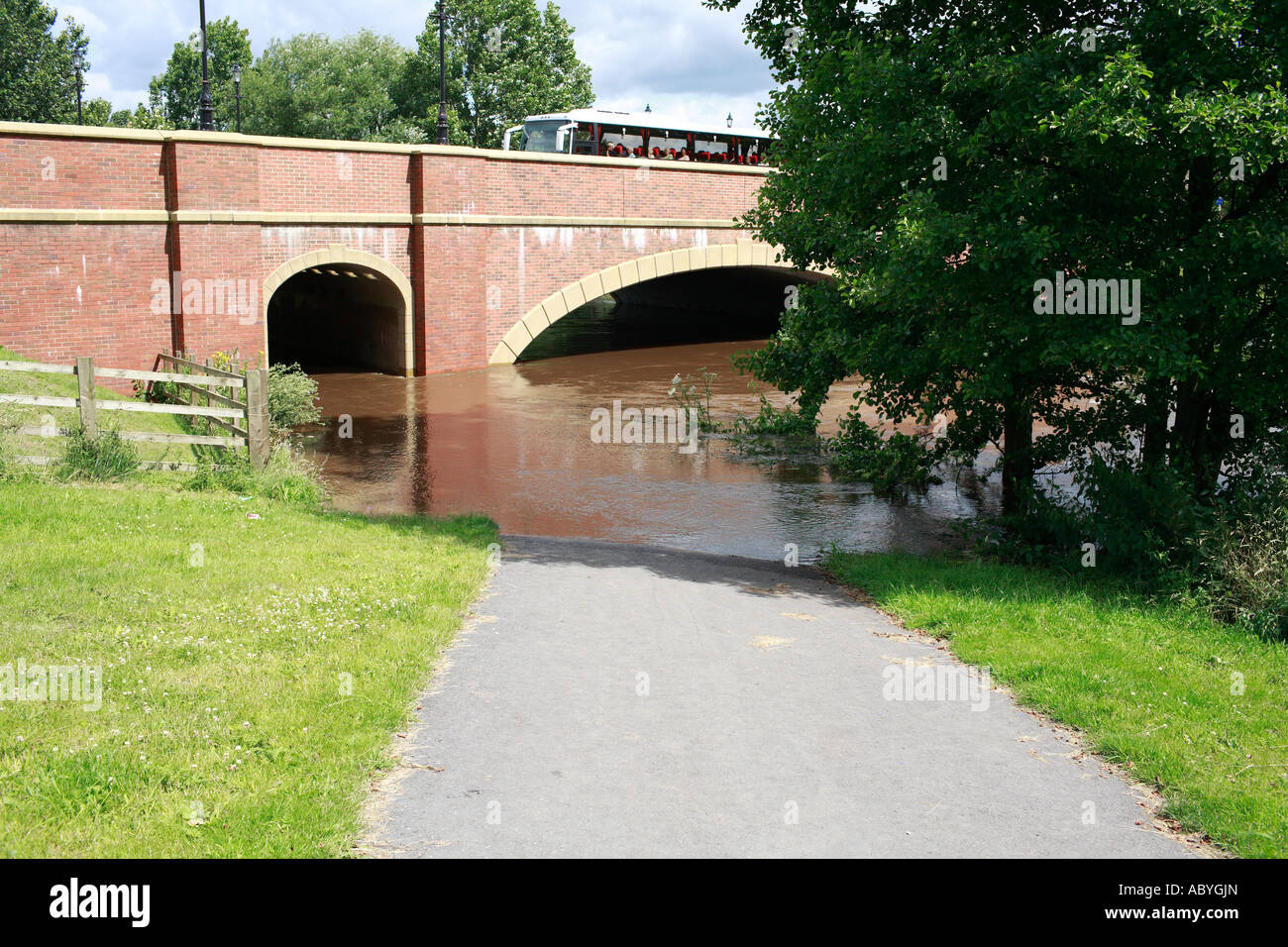 A flooded walkway and River Weaver alongside a bridge in Nantwich ...