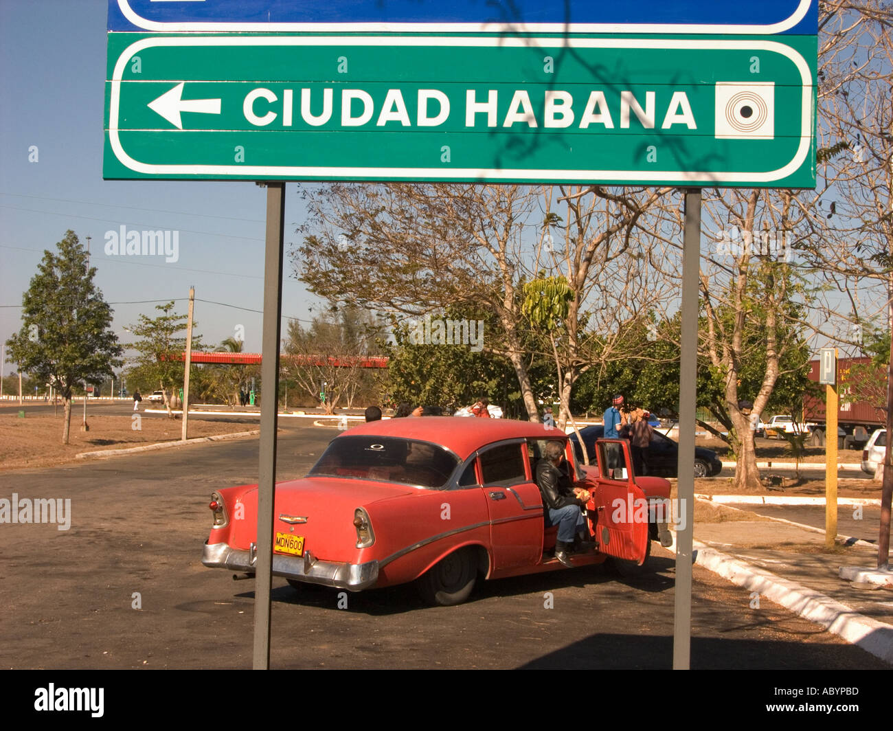 cuba sign post to city of havana with parked chevrolet Stock Photo - Alamy