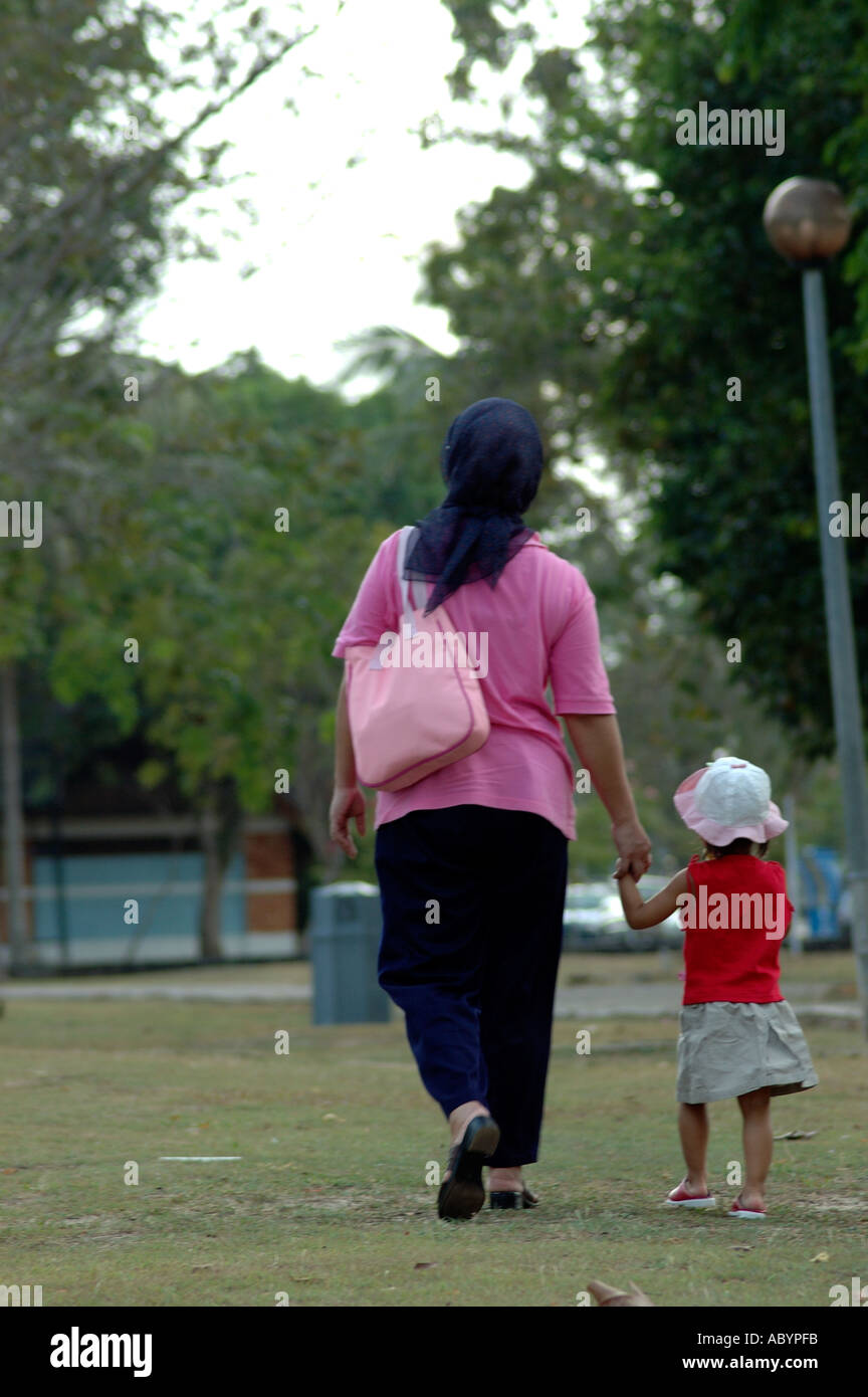 Mother walking a child Stock Photo - Alamy
