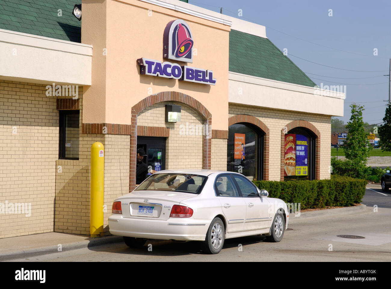 Customer in a car pickup up food from a fast food restaurant Stock ...