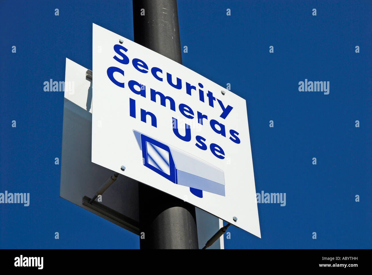 Warning sign stating security cameras are in use to protect the public ...