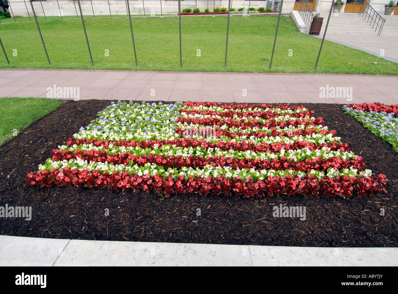United States flag made from flowers in front of the state capitol ...