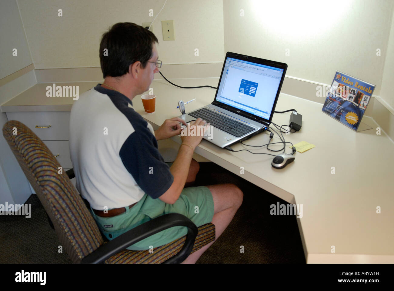 Businessman works on a laptop computer in a hotel room Stock Photo - Alamy