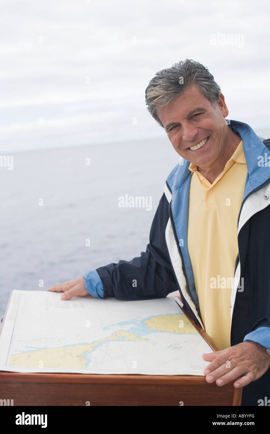 Man reading map on ship Stock Photo - Alamy