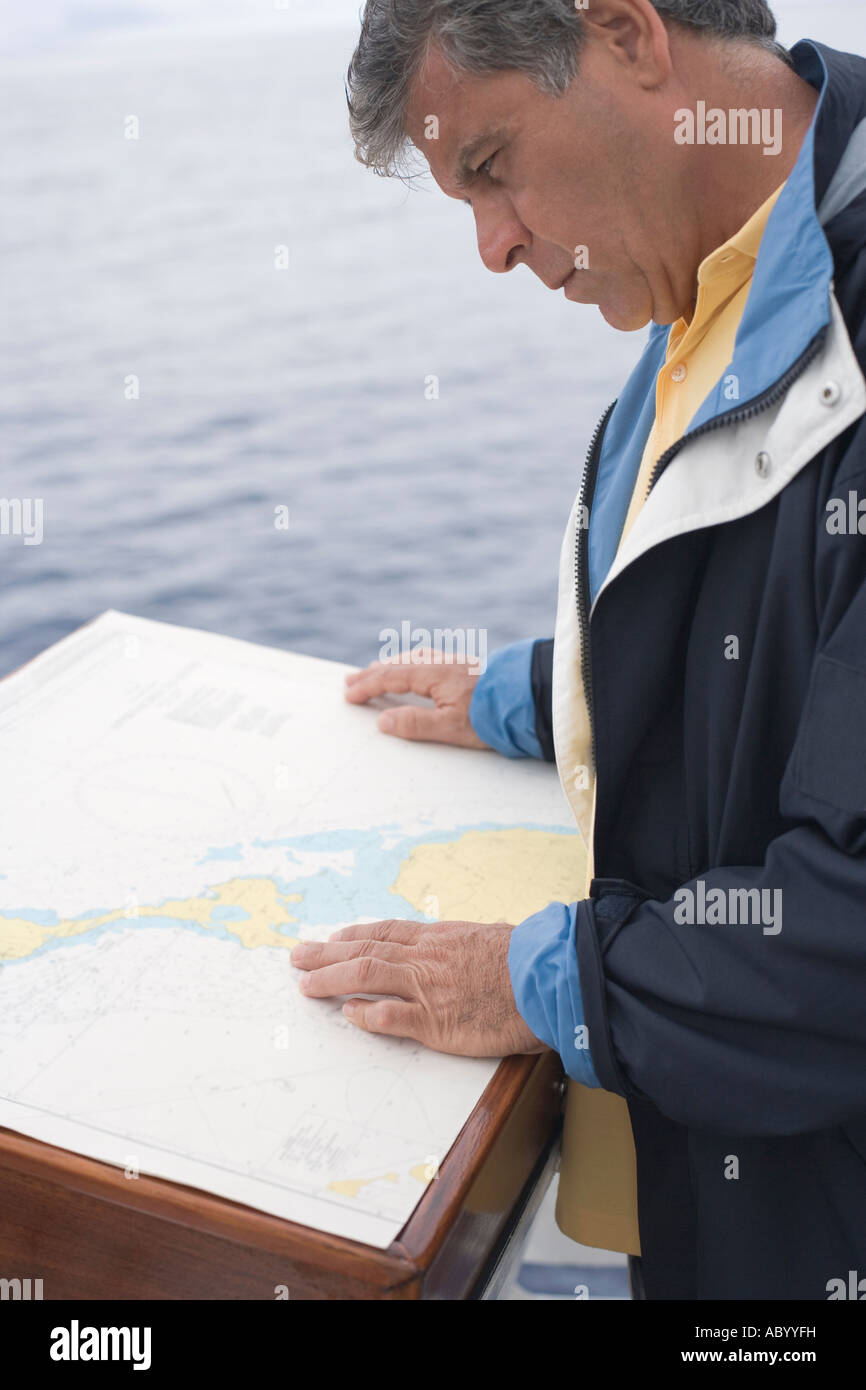 Man reading map on ship Stock Photo - Alamy