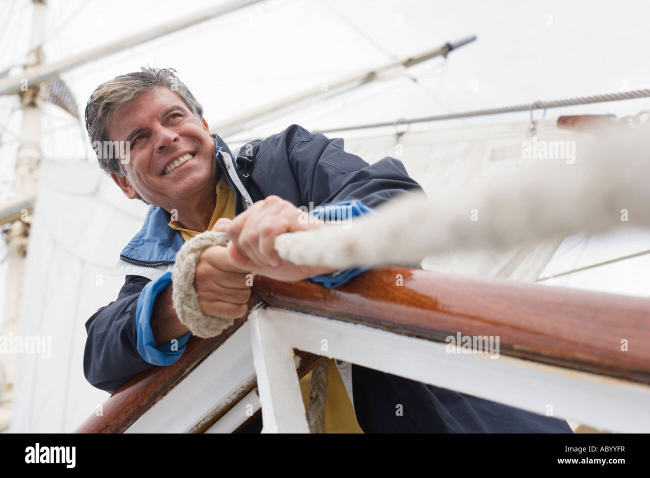 Man pulling ship’s rigging Stock Photo - Alamy
