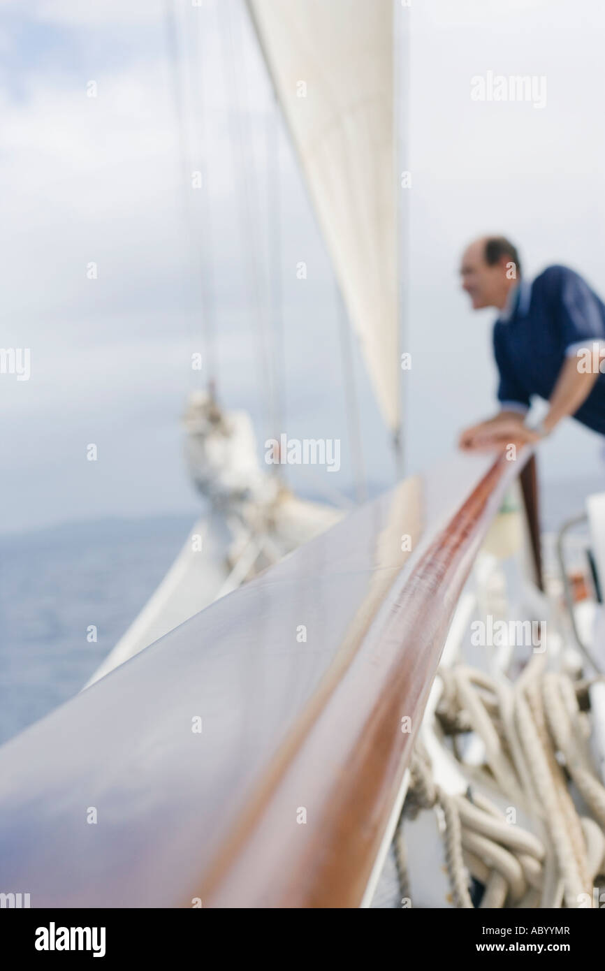 Man standing on ship deck Stock Photo - Alamy