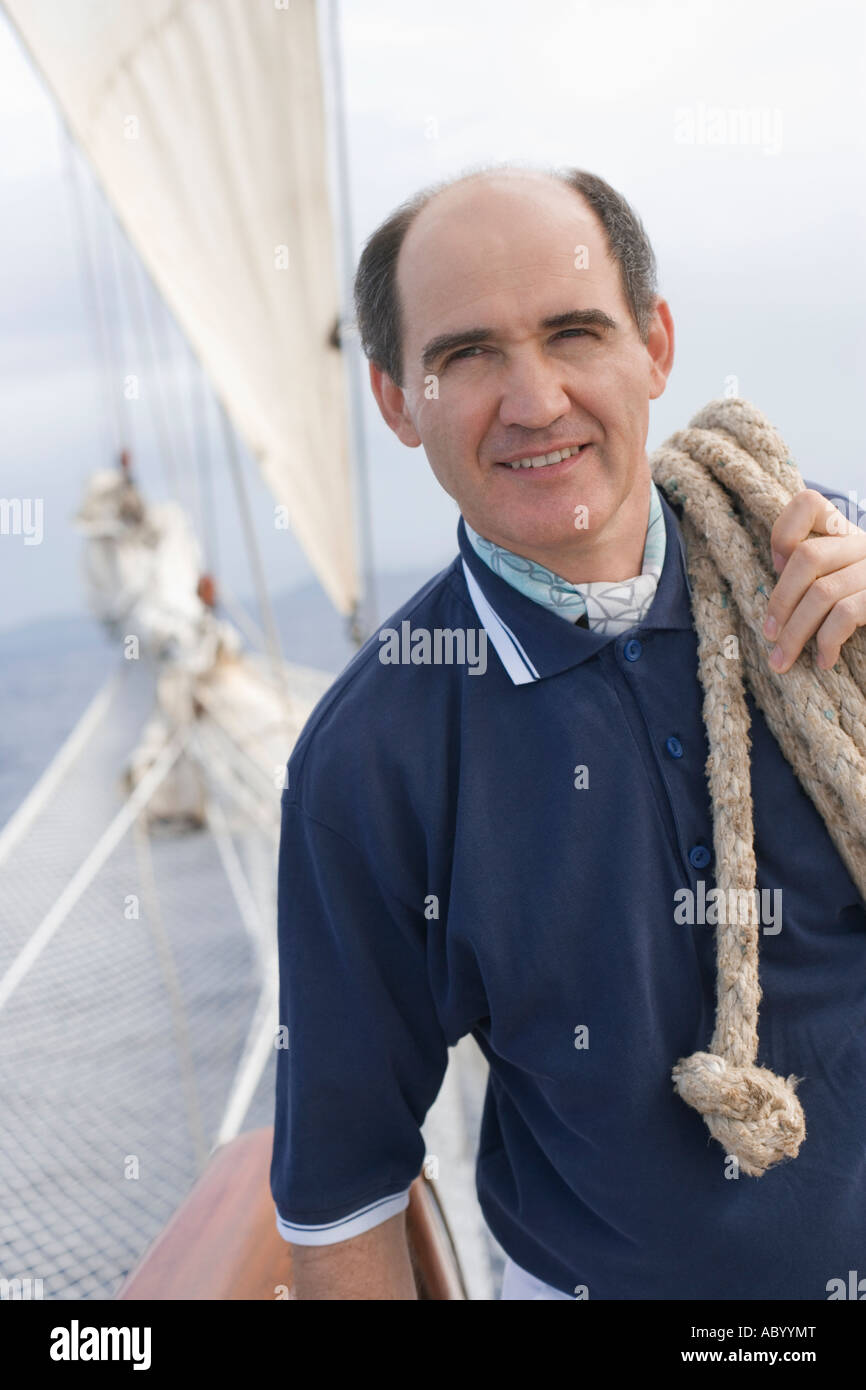 Man carrying rigging on ship Stock Photo - Alamy