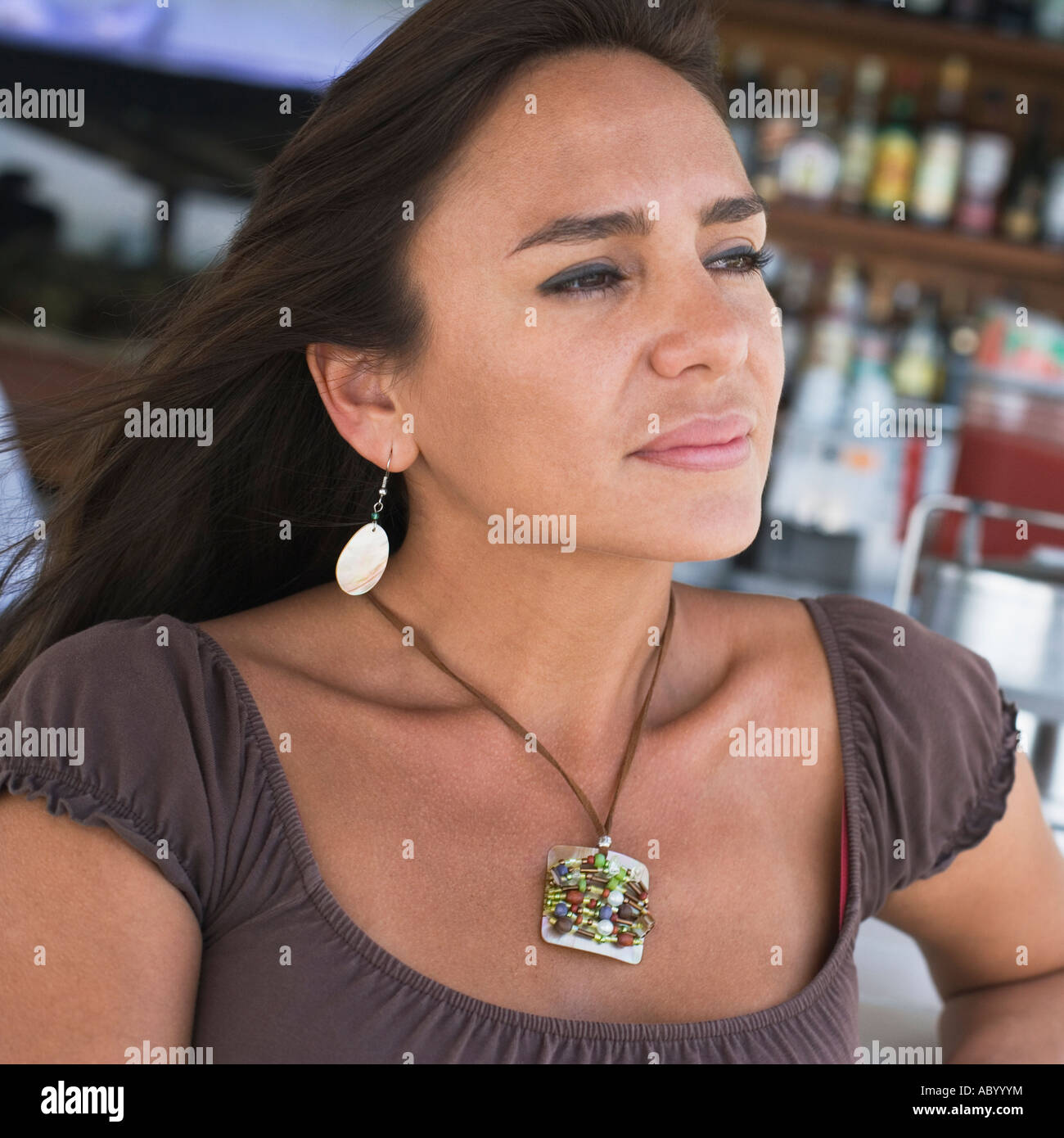 Woman leaning on counter Stock Photo - Alamy