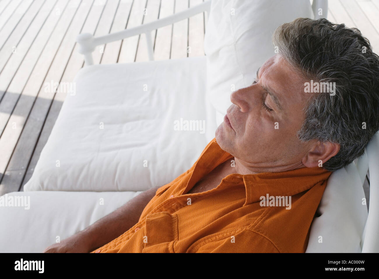 Man relaxing on couch Stock Photo - Alamy