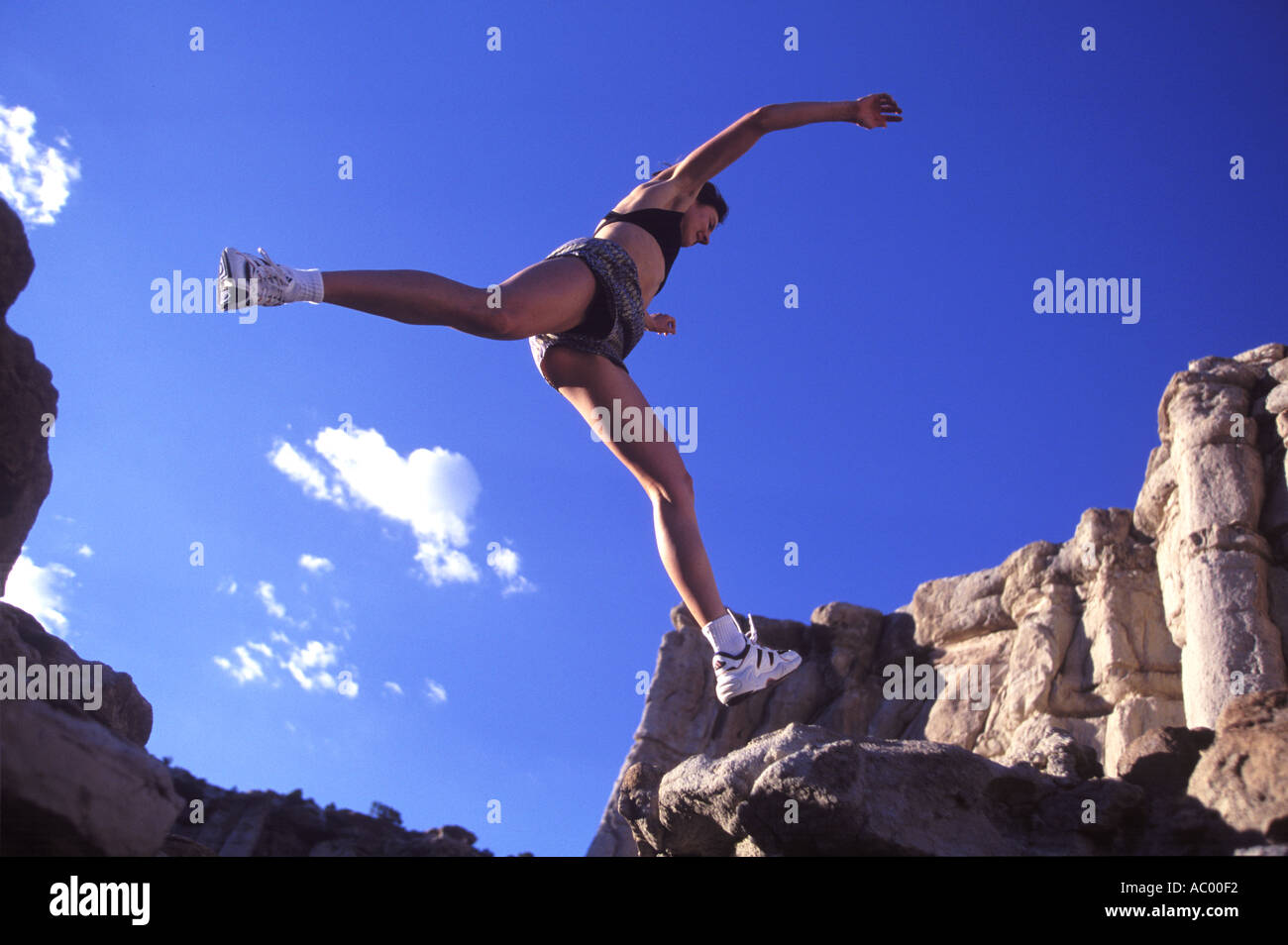 Woman leaping between rocks hi-res stock photography and images - Alamy