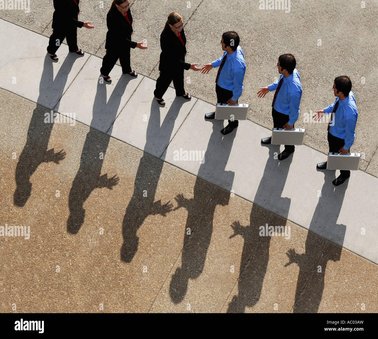 Cloned businessman and woman with shadow shaking hands on concrete ...