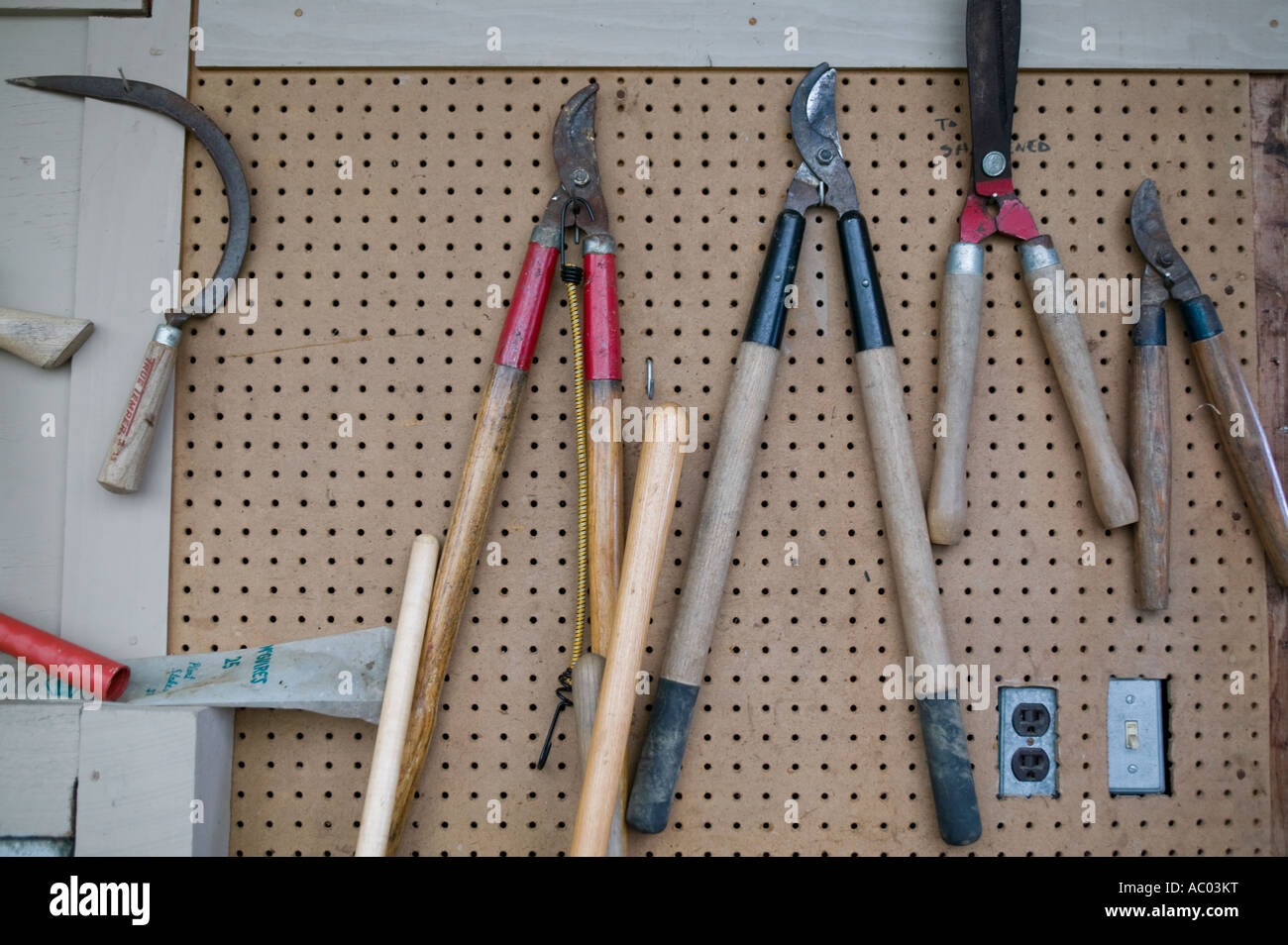 Clippers and tools for cutting hanging on the wall Stock Photo - Alamy