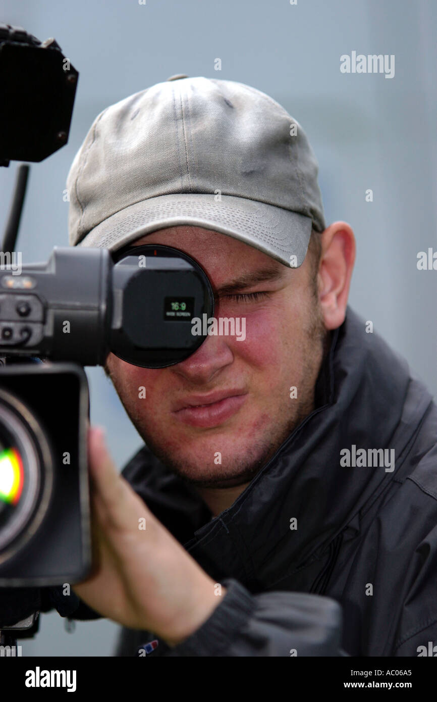 a cameraman at work looking through the viewfinder Stock Photo - Alamy