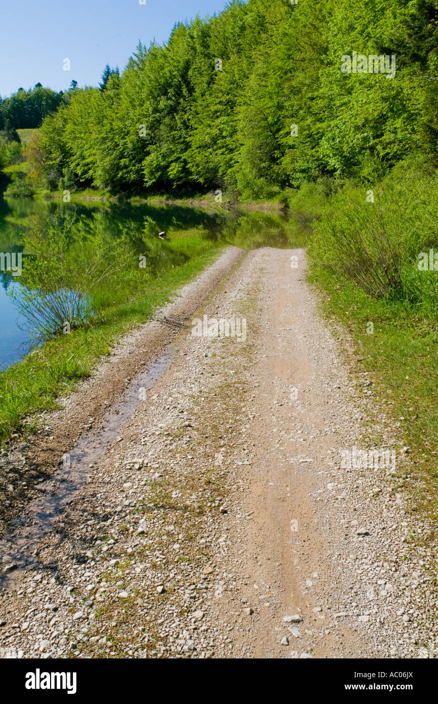 Vanishing country road into water Stock Photo - Alamy