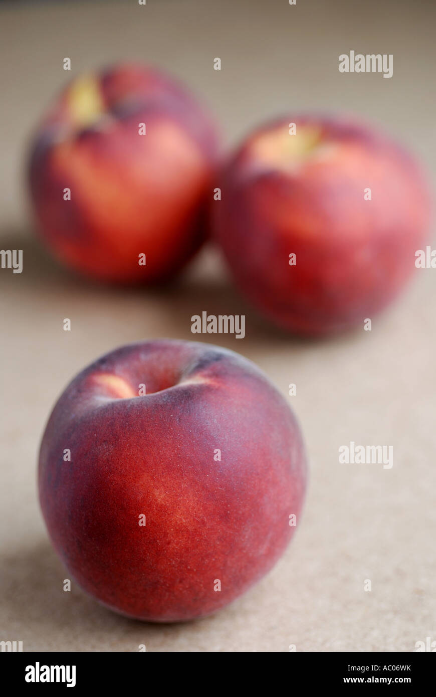 FRESH ORGANIC YELLOW FLESH PEACHES ON A TEXTURED BACKGROUND VARIETY ...