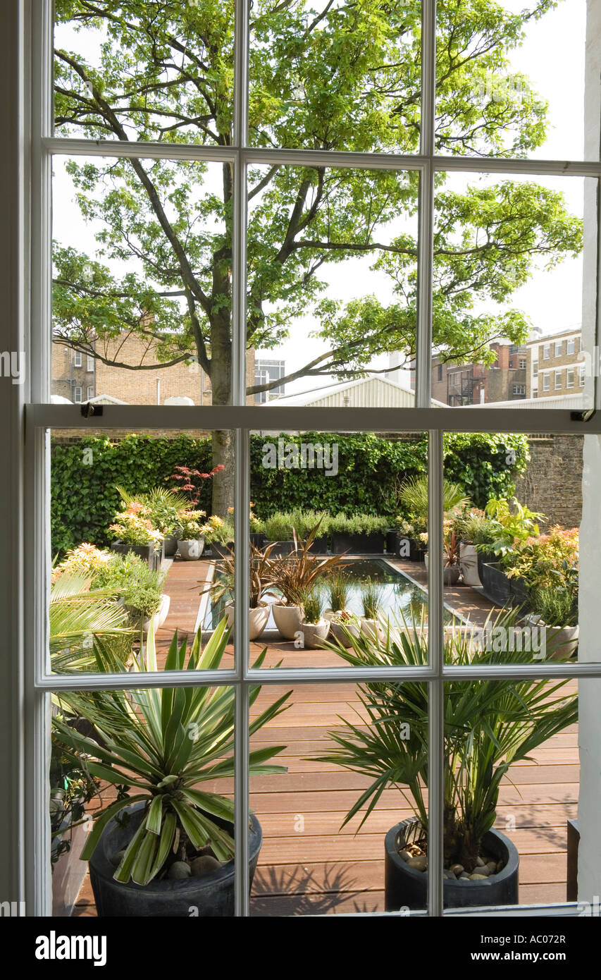 View through window to decked garden terrace with glass roof Stock ...