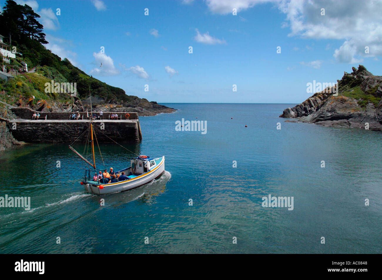 Boat leaving Harbour Stock Photo - Alamy