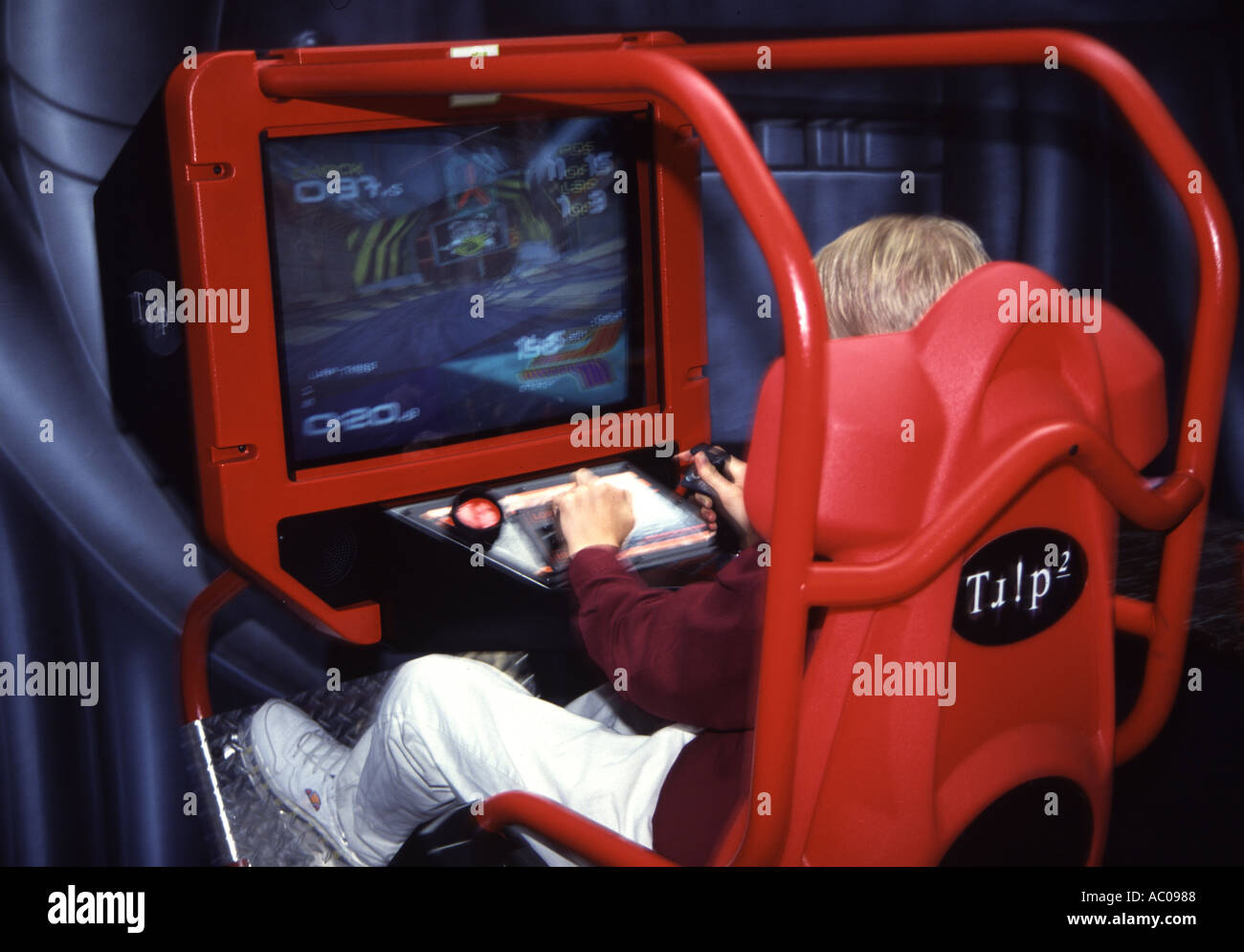 Young boy playing a video arcade game Stock Photo - Alamy
