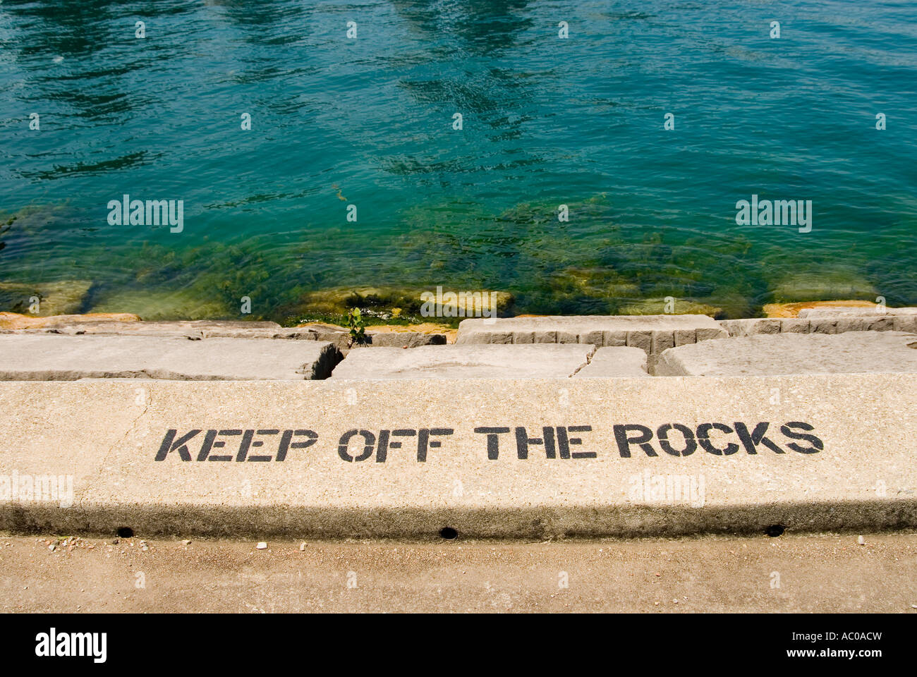 "Keep Off the Rocks" sign on break wall Stock Photo - Alamy