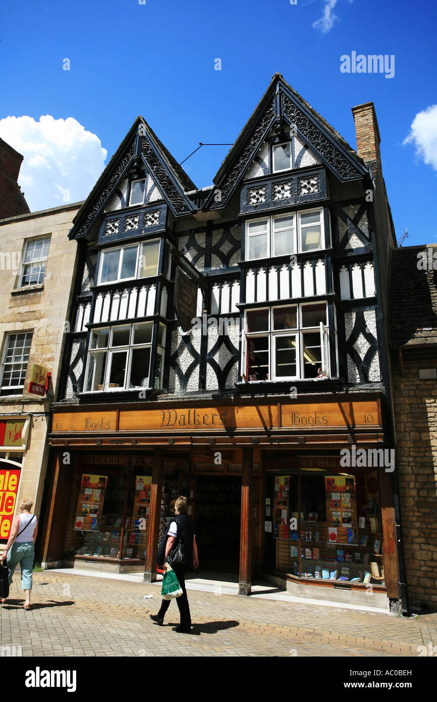 Tourists walk past a typical black wooden Tudor fronted shop house in ...